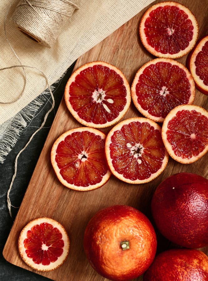 Red Blood Orange Slice on a Wooden Board, Top View Stock Photo - Image ...
