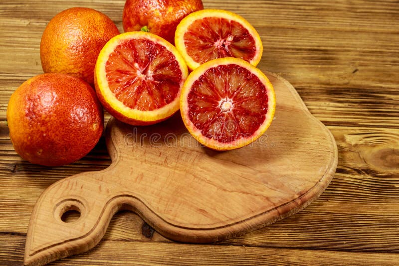 Red Blood Oranges on Wooden Table Stock Photo - Image of nature, board ...