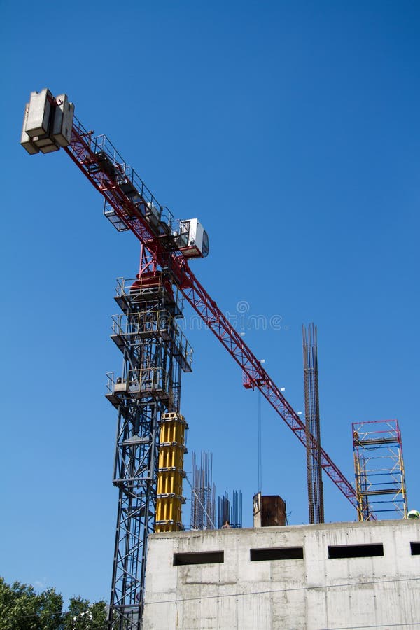 Red-blue Crane Near the Wall of a Multistory Building Under ...