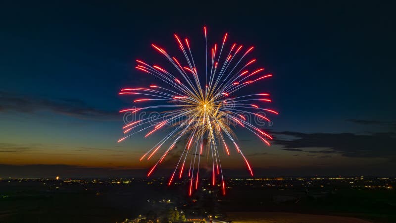 Red and Blue Fireworks Exploding in the Night Sky, Casting Bright ...