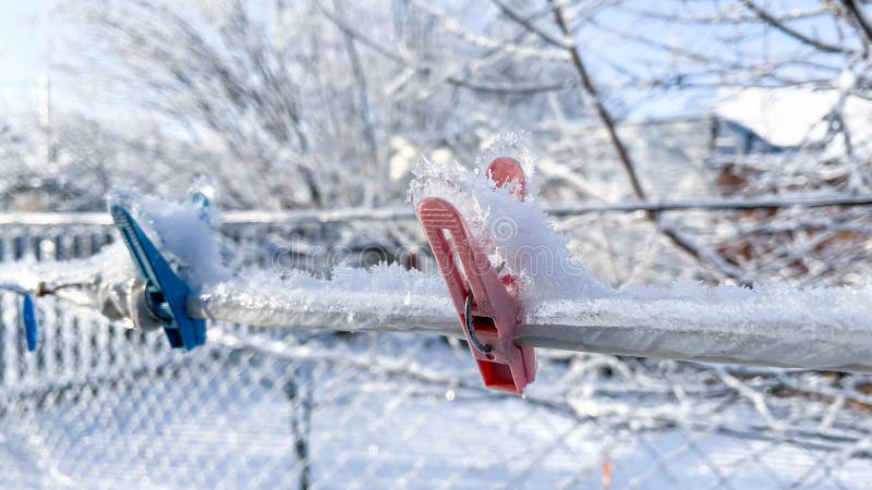 Red and Blue Frozen Clothespin on a Wire Stock Photo - Image of outdoor ...
