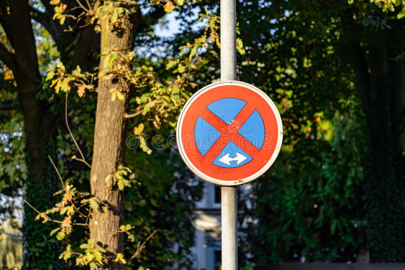 A Red and Blue Sign with a White X on it is on a Pole Stock Image ...