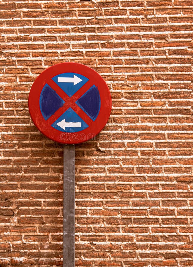 Red and Blue Traffic Sign Next To a Brick Wall Stock Image - Image of ...