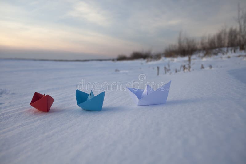 Red, Blue and White Paper Boat in the Snow Stock Photo - Image of ...