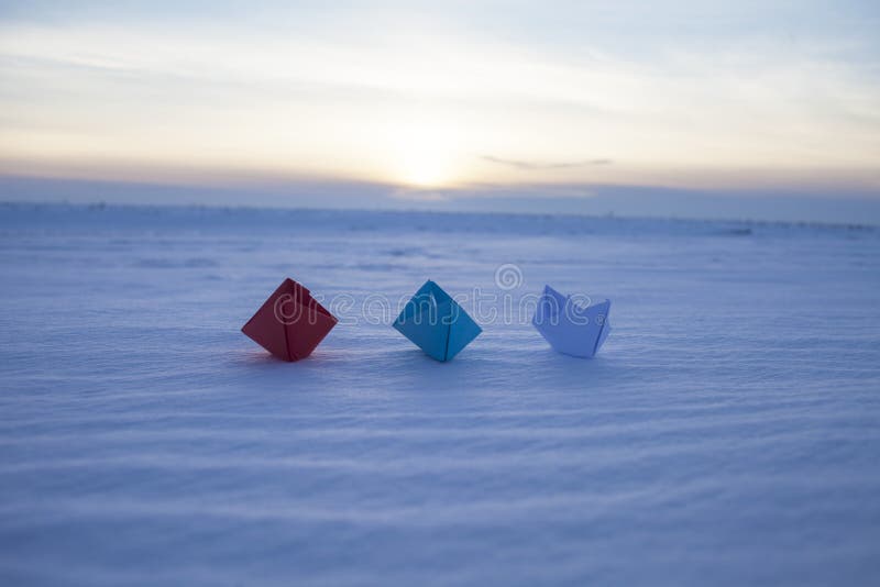 Red, Blue and White Paper Boat in the Snow Stock Image - Image of ...
