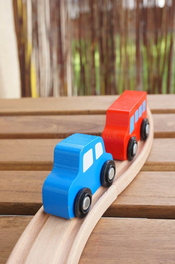 Red and a Blue Wooden Bus Toys on Tracks on a Wooden Surface Stock ...