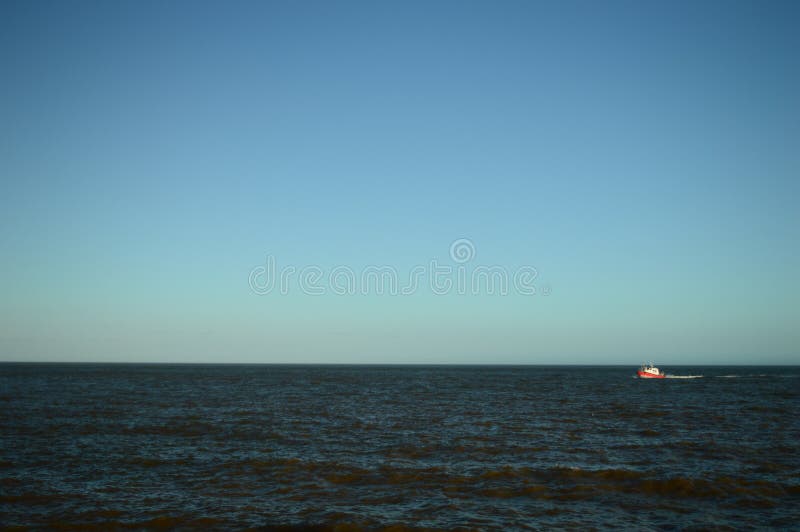 Red boat in the horizon stock image. Image of clouds - 81672243