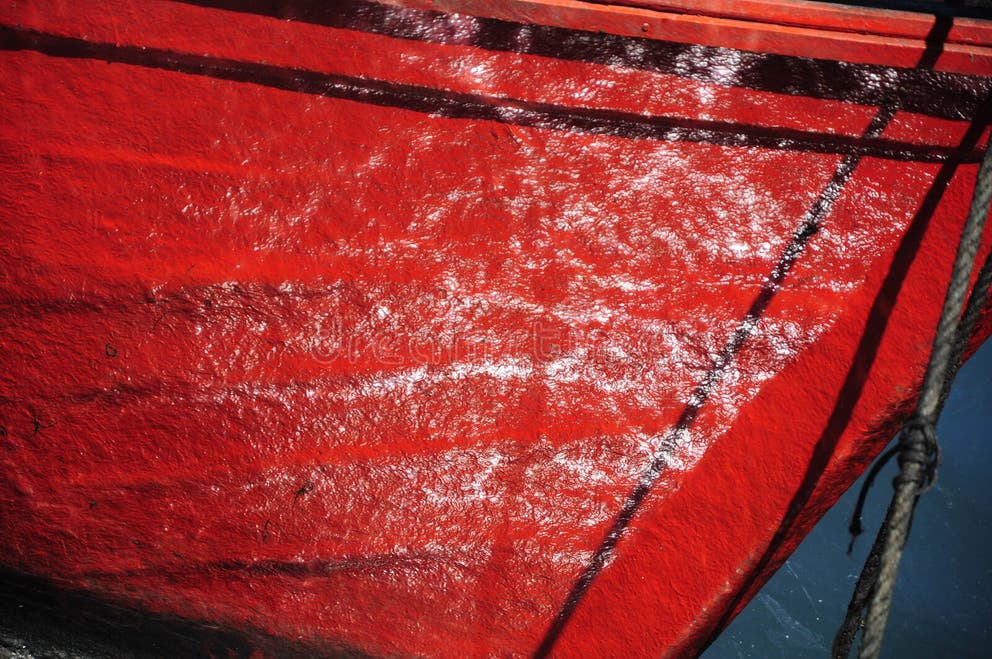 Red Boat Hull Glistening in Sunlight with Dynamic Shadows Stock ...
