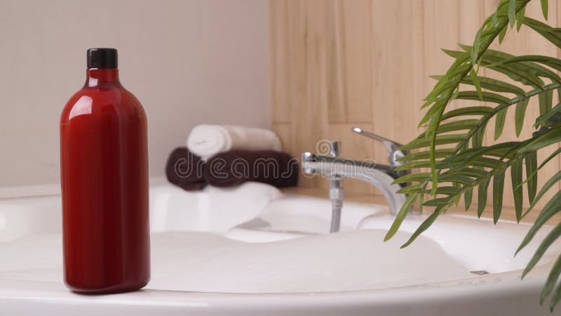 Red Bottle of Bath Foam and Towels on Tub Indoors, Space for Text Stock ...