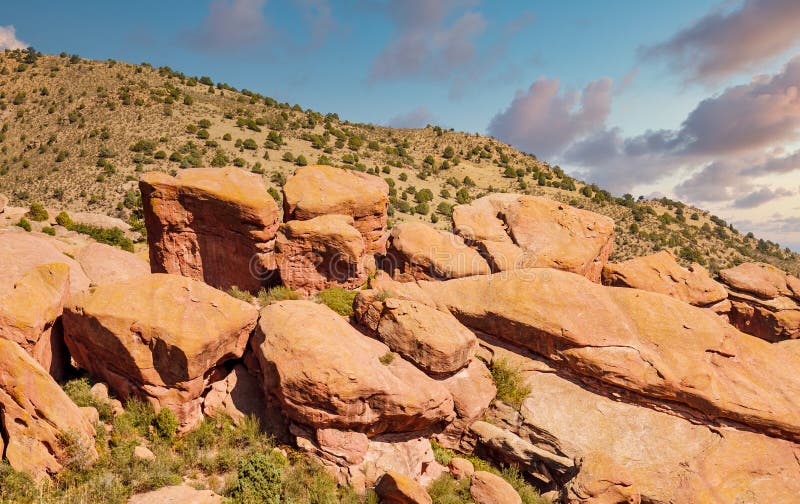 Red Boulders on Desert Hillside Stock Photo - Image of desserted ...