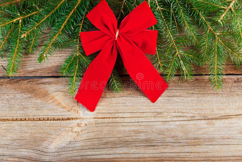 Red Bow and Fir Tree Branch on Wooden Board Stock Photo - Image of ...