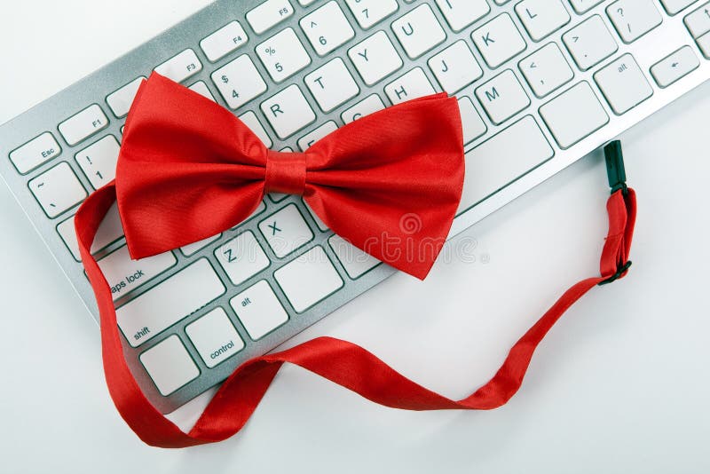 Red Bow-tie on a White Computer Keyboard Stock Photo - Image of music ...
