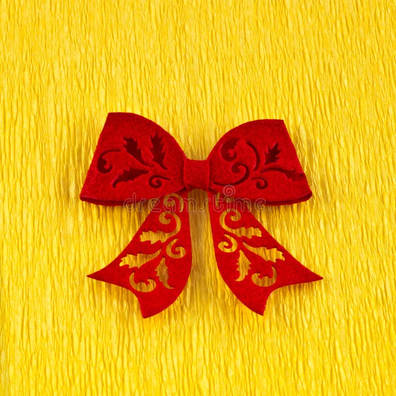 Red bow on yellow paper stock image. Image of ornamental - 30365669