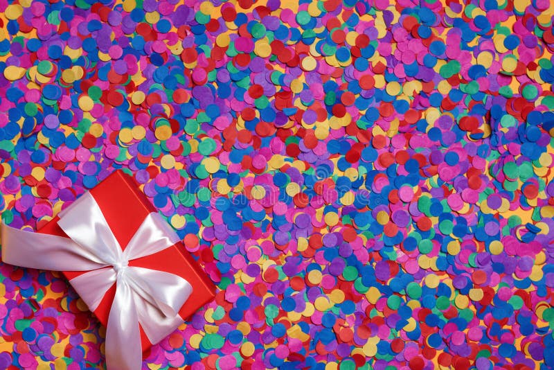 Red Box with a Gift on Scattered Confetti. Top View Stock Photo - Image ...