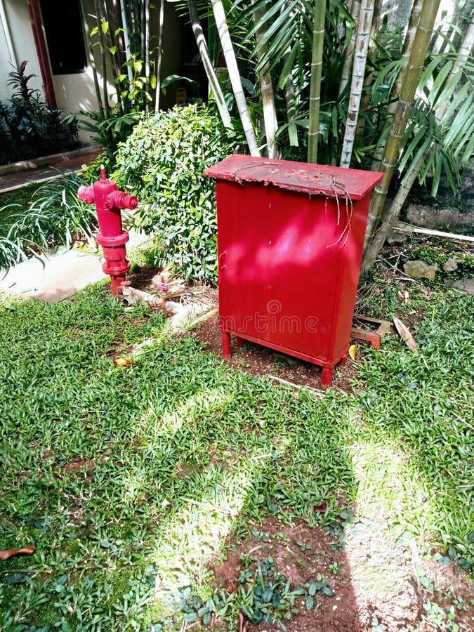 Red Box and Water Hydrant Pump in the Middle of the Park Stock Photo ...