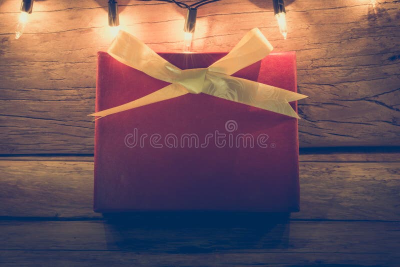 Red Box on a Wooden Table and Old Light Bulbs To Decorate. Stock Photo ...