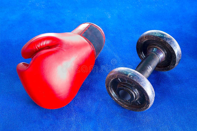 Red Boxing Glove and Old Dumbbells on Blue Exercise Mat Stock Image ...