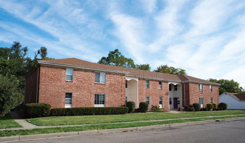 Red Brick Apartment Complex Stock Image - Image of clouds, apartment ...