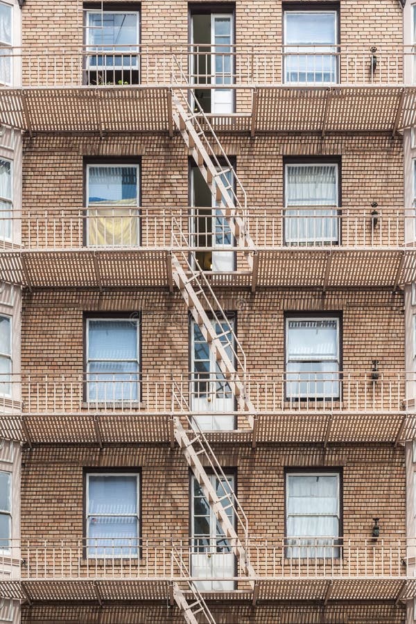Red Brick Building with Fire Stairs Stock Photo - Image of iron, urban ...