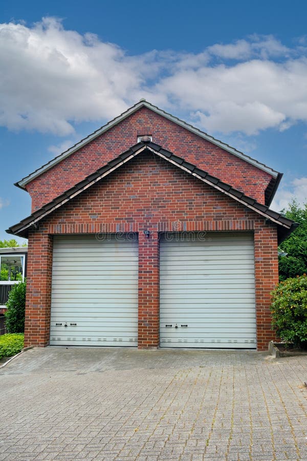 Red Brick Building with Two Garage Doors in Germany Stock Image - Image ...