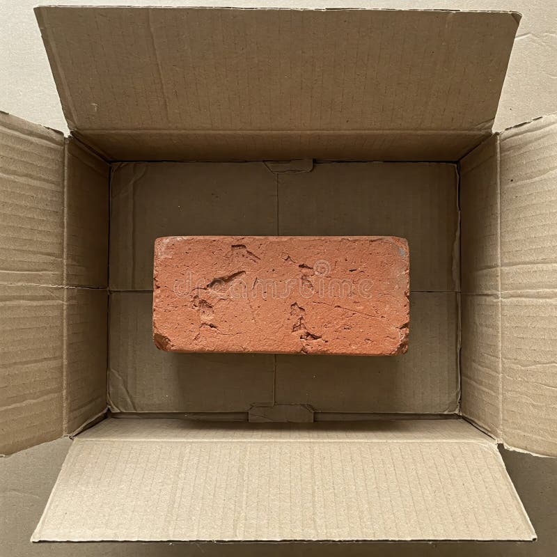 A Red Brick in the Center of a Cardboard Box. Stock Image - Image of ...