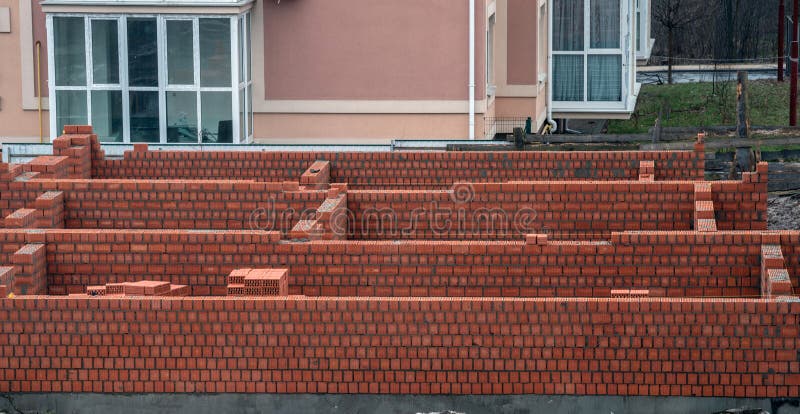 Red Brick Construction Process of a New Building in the Background of a ...