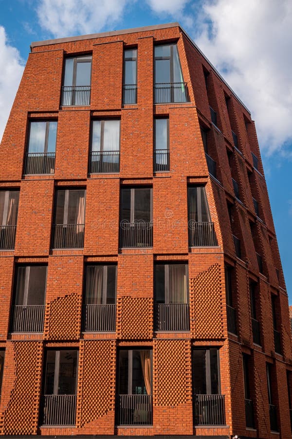 Red Brick House with Blue Sky and White Clouds in the Background in the ...