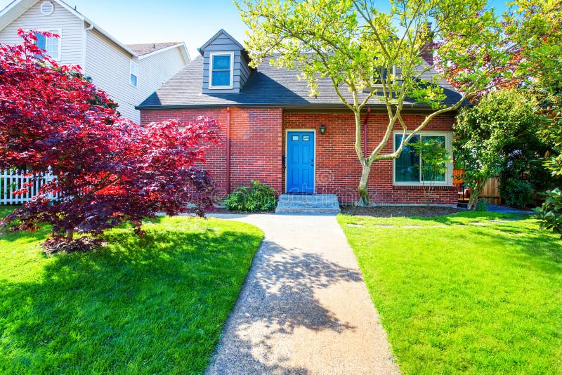 Red Brick House with Tile Roof and Maple Tree in the Front Yard Stock ...