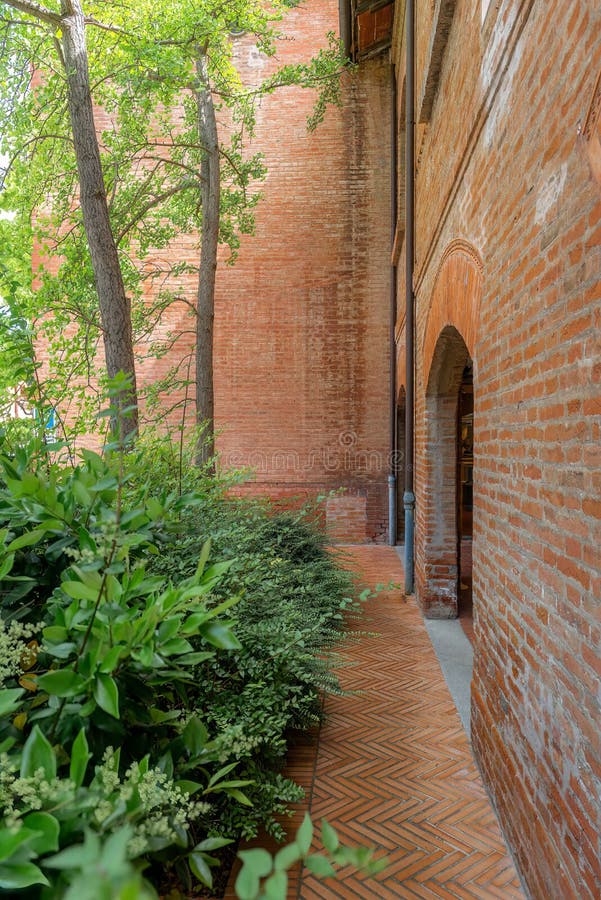 Red Brick Path in a Herringbone Pattern at the Base of a Building in ...