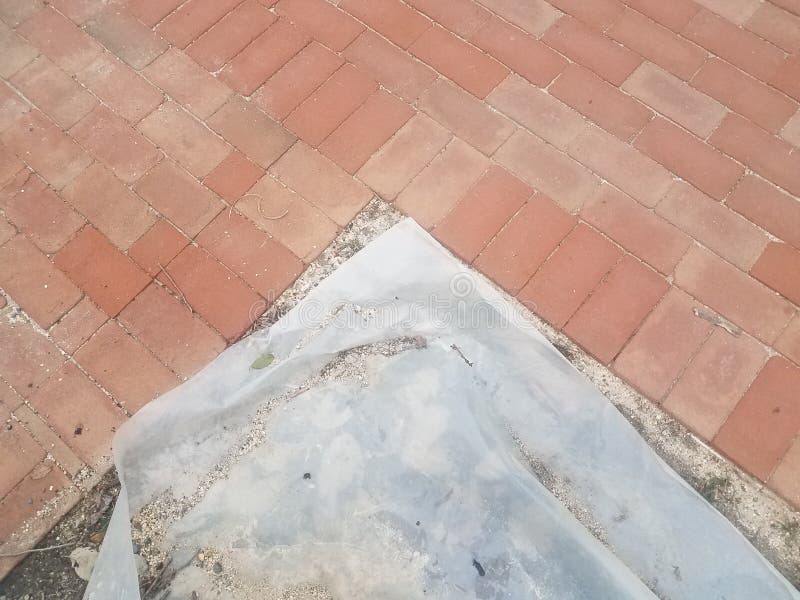 Red Brick Sidewalk and Ground with Plastic Covering Stock Photo - Image ...