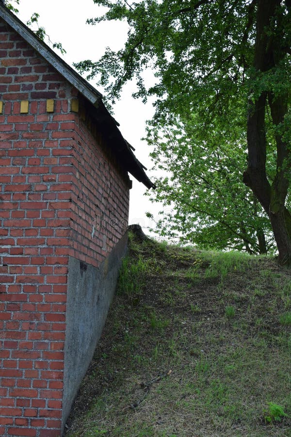 Red Brick Wall of a Building Half Under Earth Level Stock Photo - Image ...