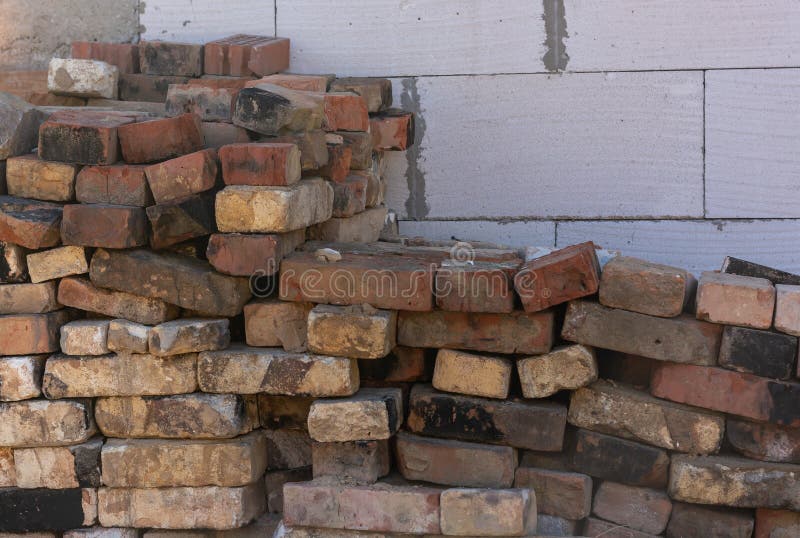 Red Bricks Piled Against a White Wall Close Up Stock Photo - Image of ...