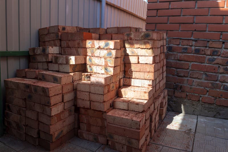 Red Bricks Stacked on a Construction Site Close-up. Building Stone ...