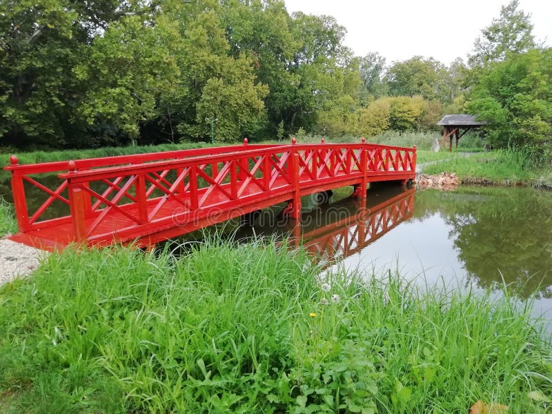 A red bridge on the lake. stock photo. Image of river - 274021372