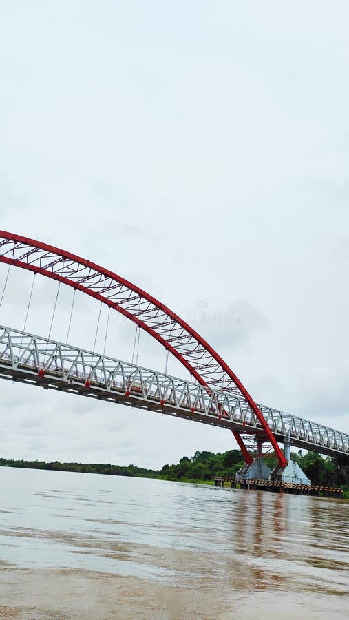 Red Bridge Over the Kalimantan River Stock Photo - Image of city ...