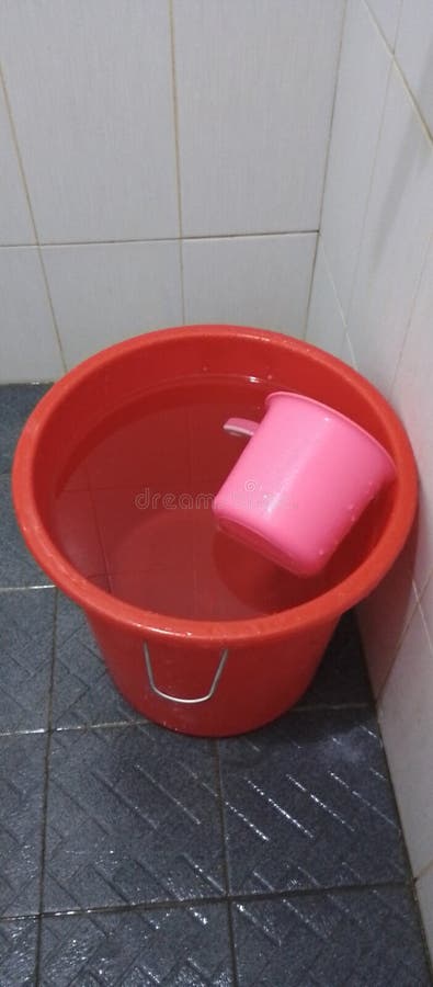 Red Bucket Filled with Water Stock Photo - Image of play, circle: 265934142
