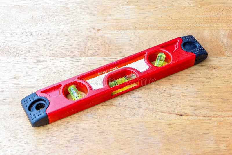 Red Building Level on a Wooden Table Background Stock Image - Image of ...