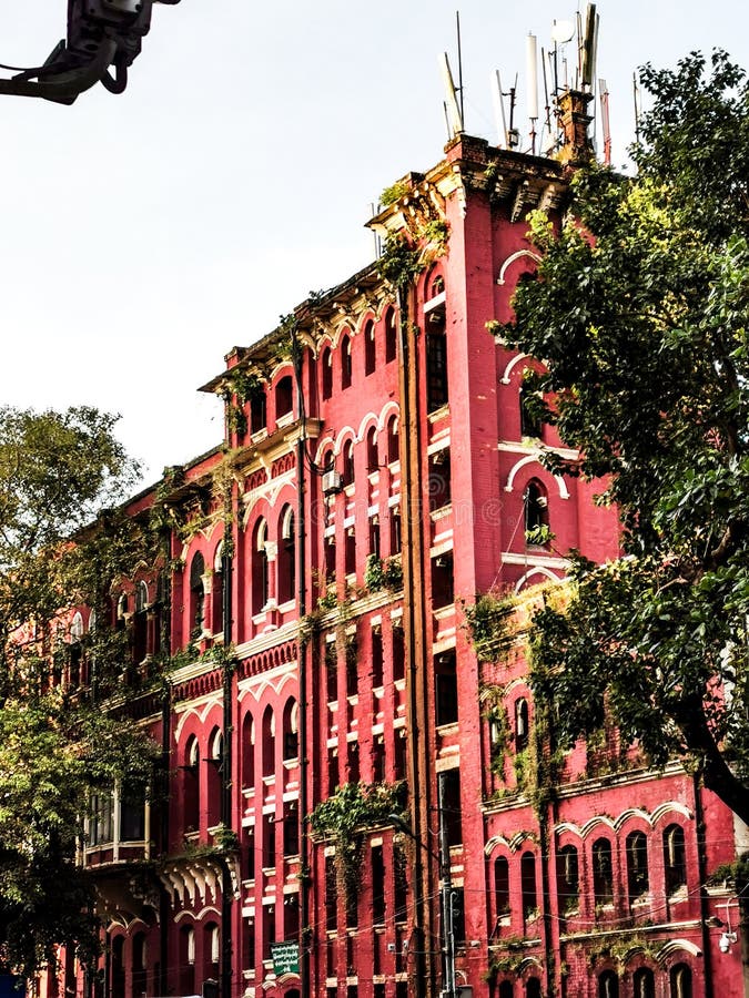 A red building in Yangon stock image. Image of road - 200284155