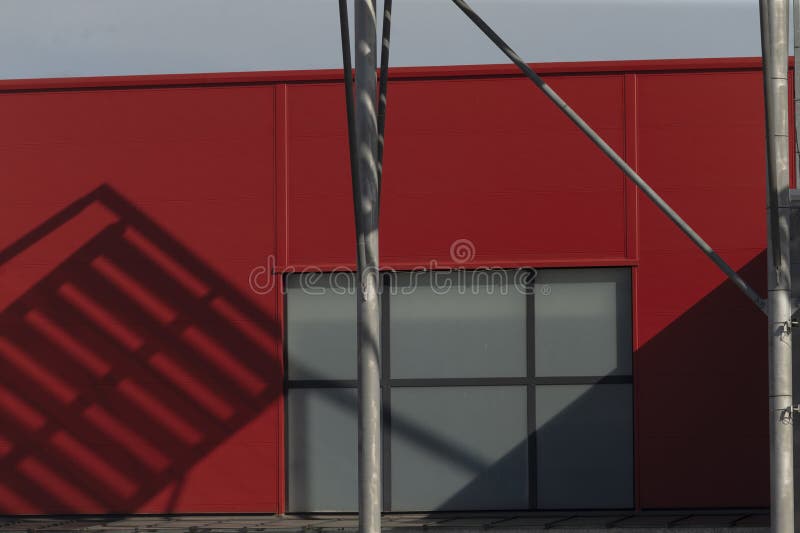 A Red Building with a Unique Pallet Shadow on Its Surface Stock Image ...