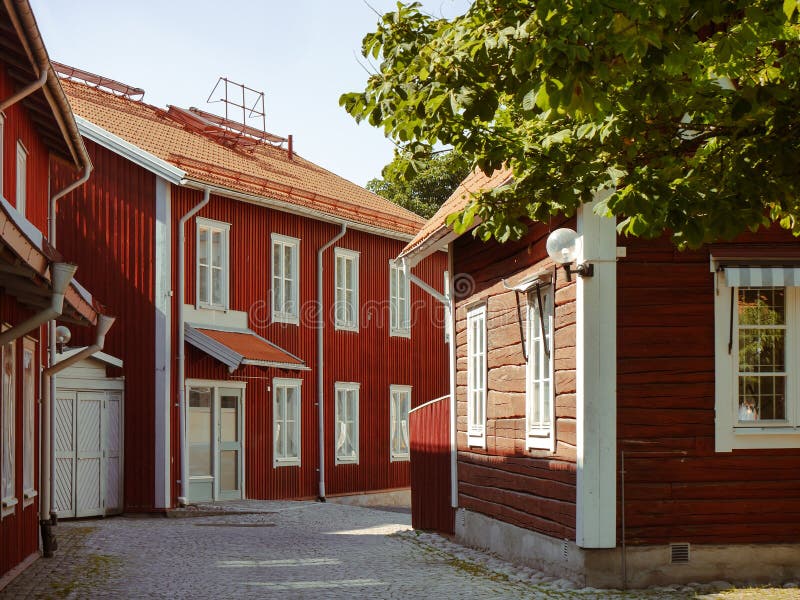 Red Buildings Along a Narrow Street Stock Photo - Image of shadow ...