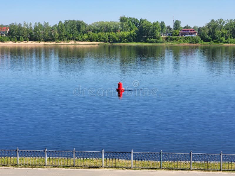A Red Buoy Bobs on a Blue Desert River Stock Photo - Image of canal ...