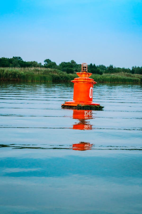 A Red Buoy on the Waves of the River. River Navigation Stock Photo ...