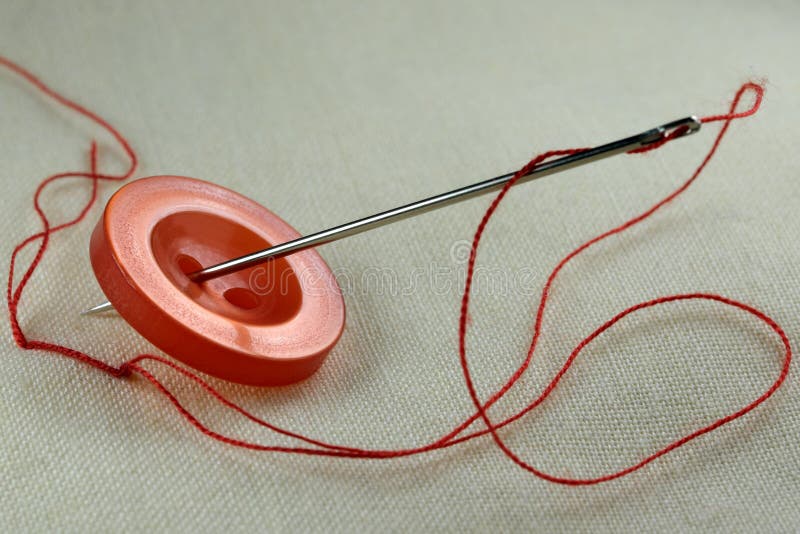 Red button with a needle stock image. Image of clothing - 236208839
