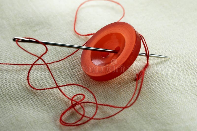 Red button with a needle stock image. Image of needlework - 236208855