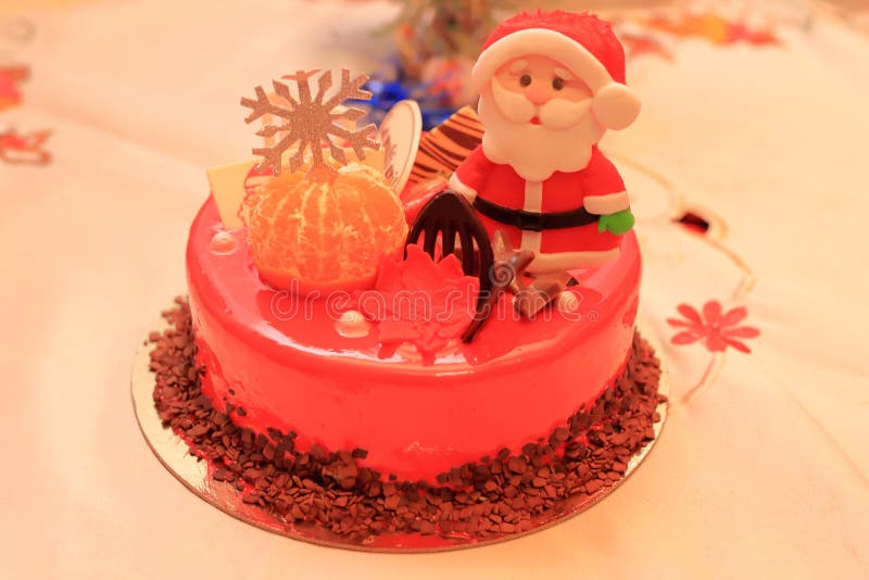 Red Cake Decorated with a Santa Figure and a Natural Orange Stock Photo ...