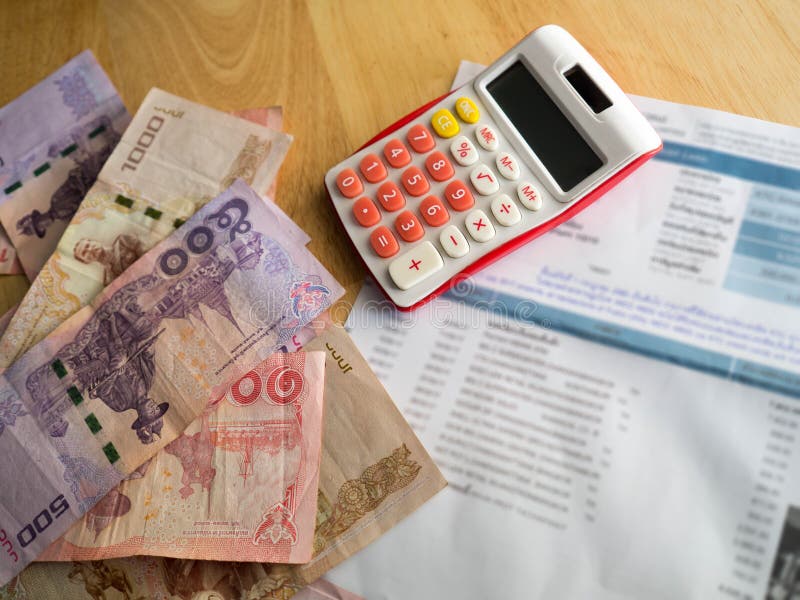 The Red Calculator and Bank Note is Placed on a Wooden Table .after ...
