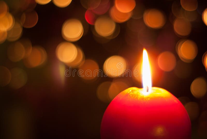Red Candle Burning with Coloured Lights Background Stock Photo - Image ...