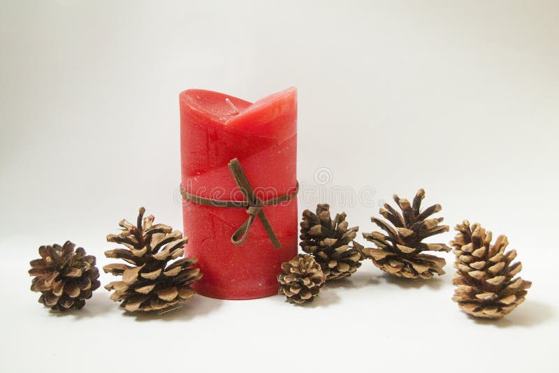 Red Candle and Pine Cones on White Backround Stock Photo - Image of ...