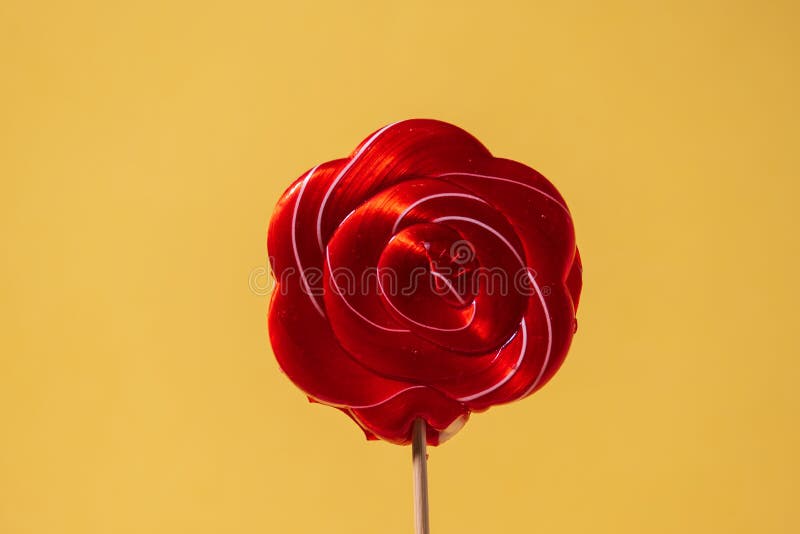 Red Candy Caramel on a Stick on a Yellow Background Stock Image - Image ...