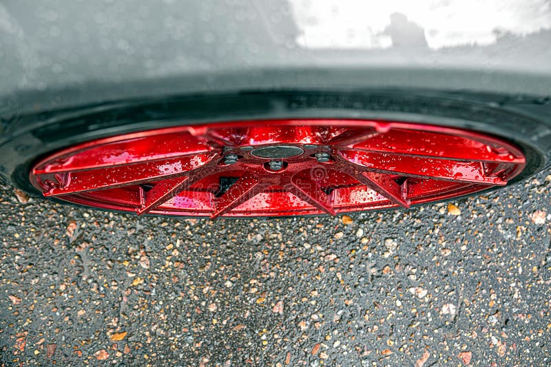 Red Candy Colored Light Alloy Wheels on Asphalt Background. in ...